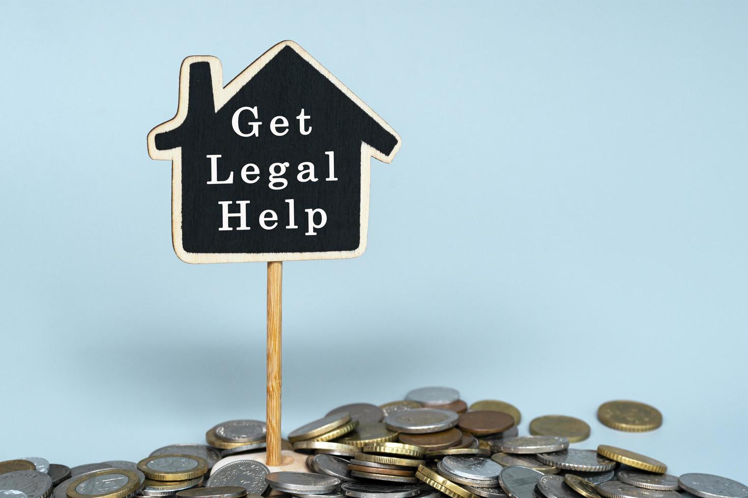 Get Legal Help Text On Wooden House With Pile Of Coins Against Blue ...